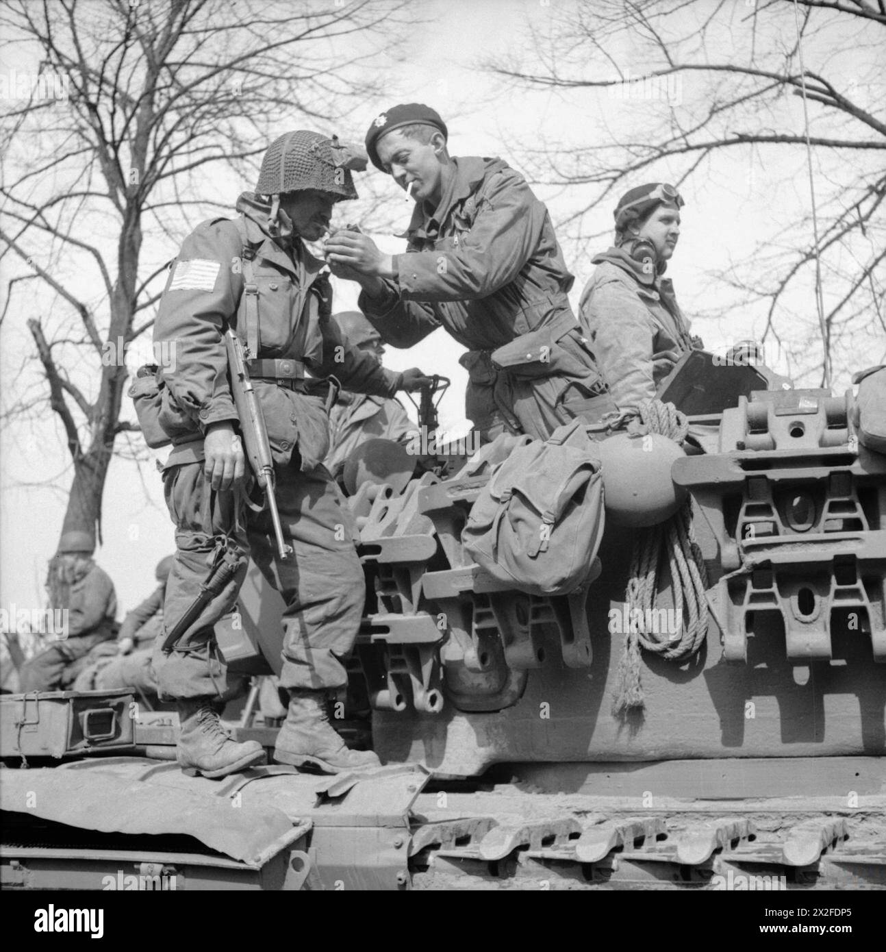An American 17th Airborne Division paratrooper receives a light from a ...