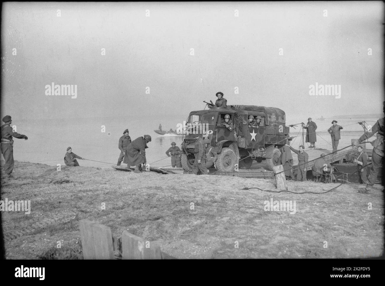 A Bedford QL military truck disembarked from a raft after crossing the ...