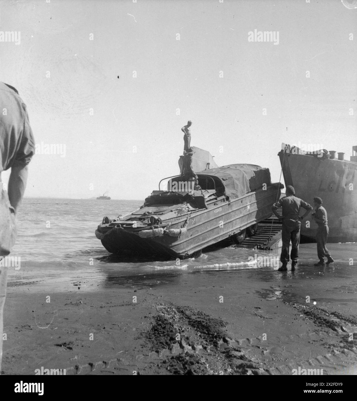 THE BRITISH ARMY IN BURMA 1945 - A DUKW reversing into a landing craft ...