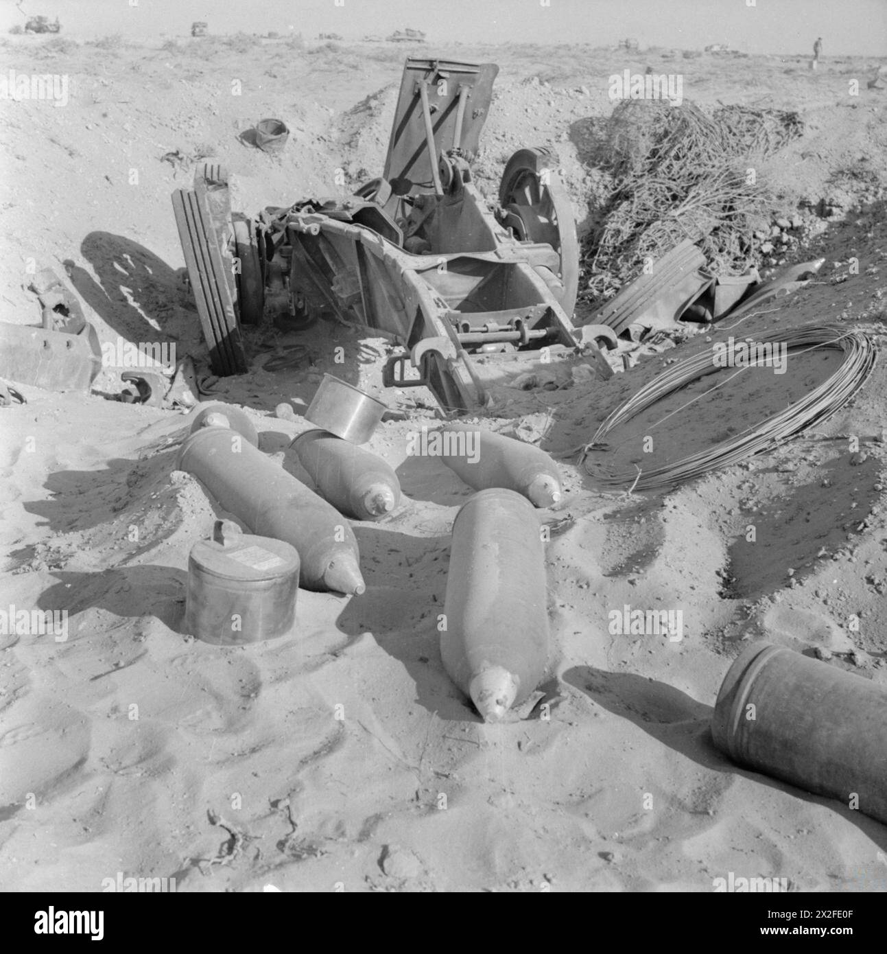 Enemy artillery shells and a destroyed gun are left on a North African ...