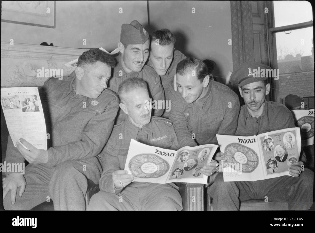 Six Jewish prisoners of war relax and read the Hebrew magazine 'Gal-Gal ...