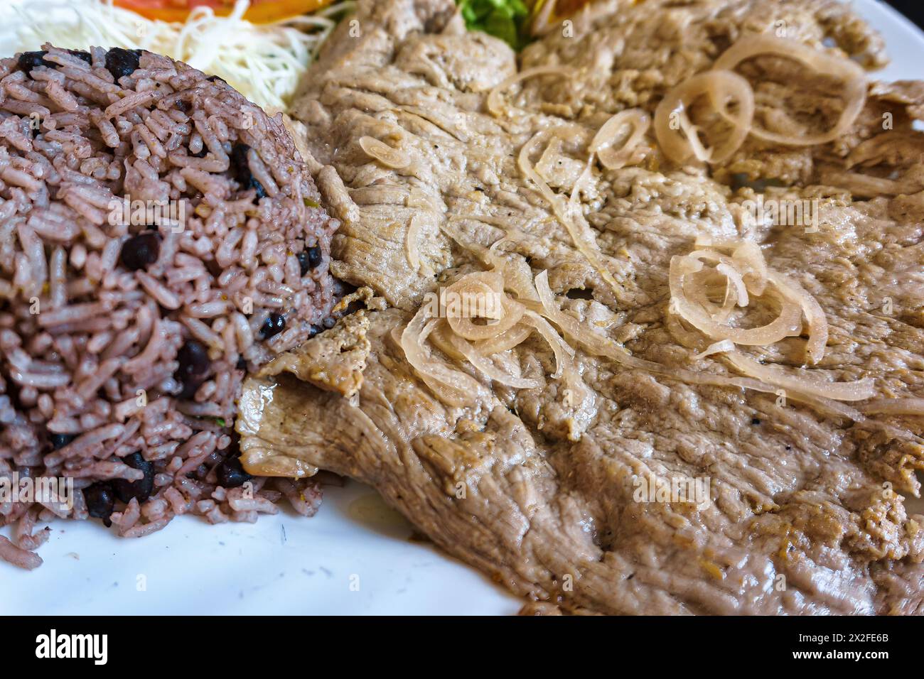 Pork steak, congri rice. Cuban cuisine Stock Photo - Alamy