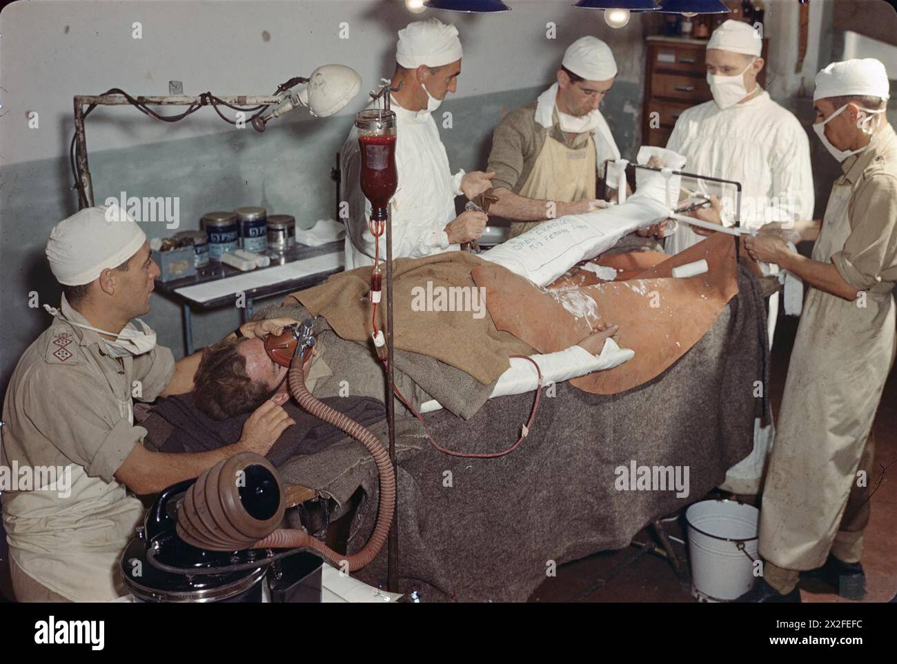 A leg-wounded patient receives a blood transfusion and plaster bandage ...