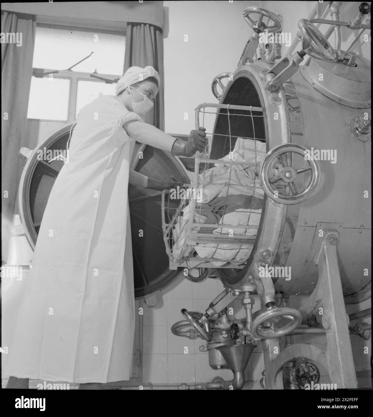 Student Nurse Joyce Collier loads an autoclave with clothing and bed ...