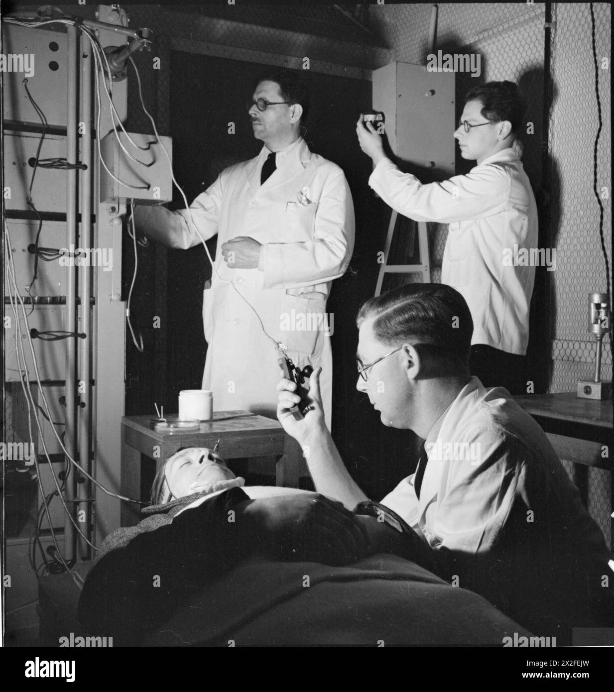 A male nurse at Runwell Hospital observes a patient undergoing Electro ...
