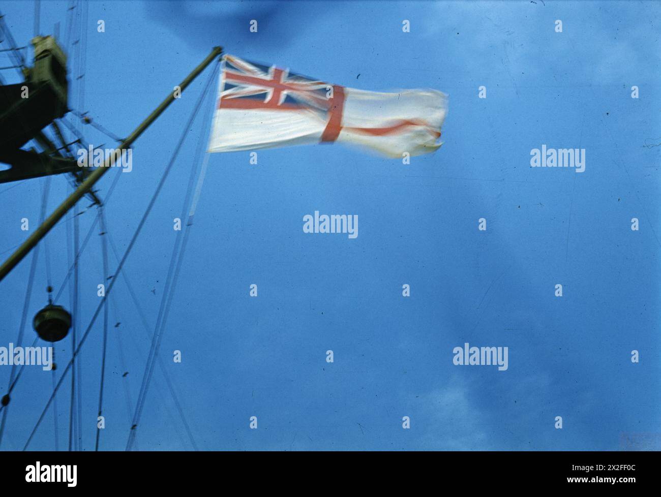 ON BOARD A BATTLESHIP, NOVEMBER 1942 - The White Ensign flying from a ...