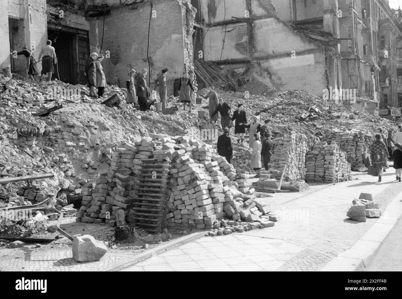 German women clear debris and salvage building materials from bomb ...