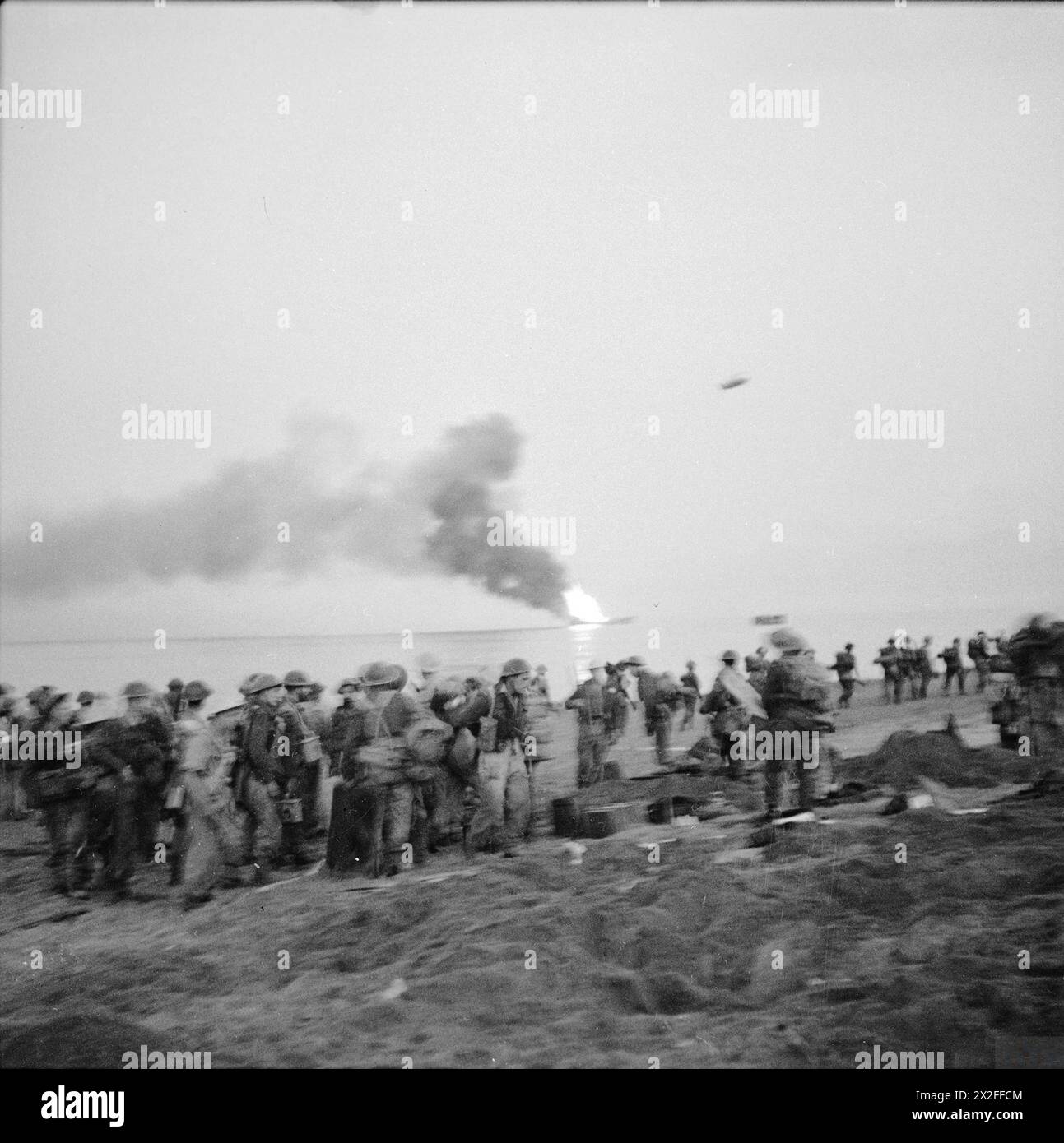 A landing craft is ablaze offshore at Salerno on 9 September 1943 ...