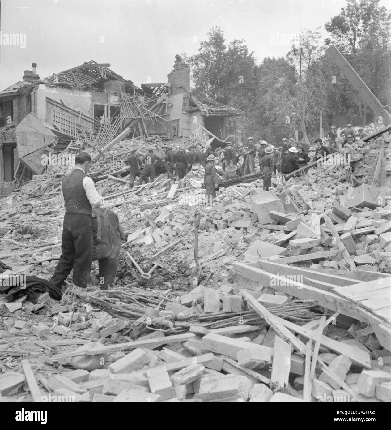 Civil Defence rescue workers in Norwood, London, 1944 clear rubble and ...