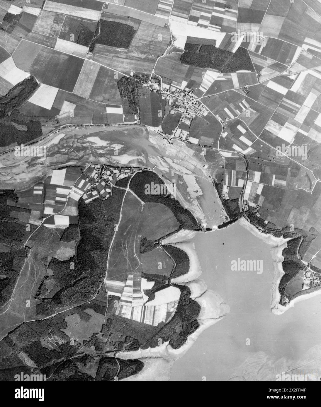 An overhead aerial reconnaissance photo of the breached Moehne Dam ...