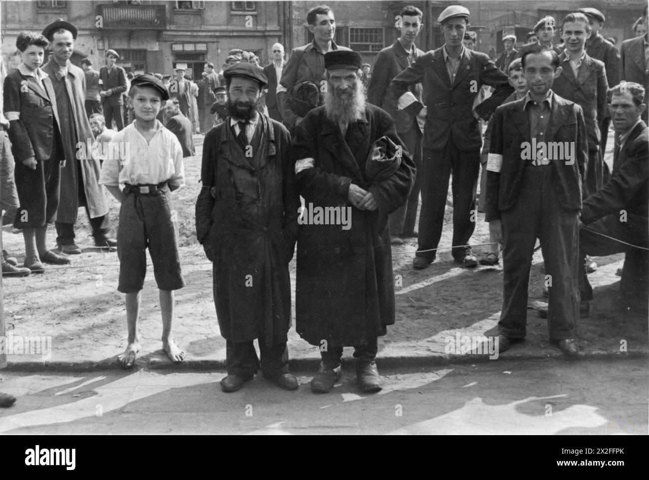 Two Jewish men are photographed in a street market in the Warsaw Ghetto ...