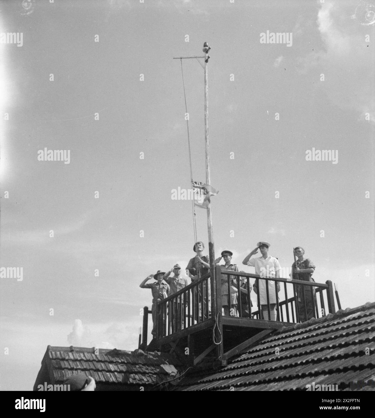 Japanese Vice Admiral Kogure salutes as Corporal Allan Jenkins raises ...