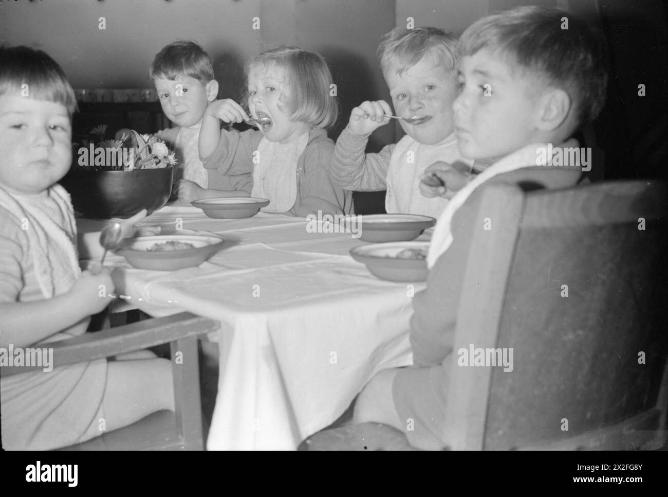 Five young children at Tapley Park, Instow, Devon, enjoy a meal of stew ...