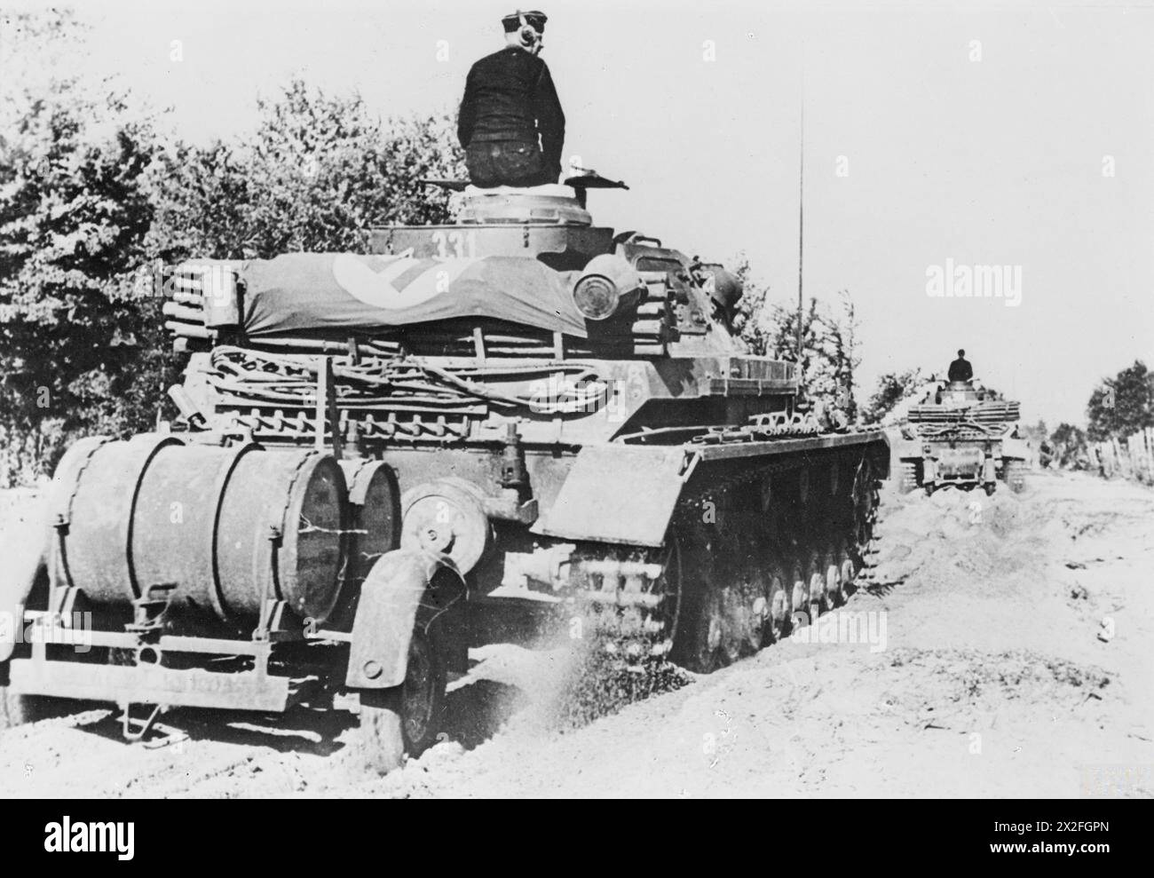 A Tauchpanzer IV submersible tank tows a fuel trailer during operations ...