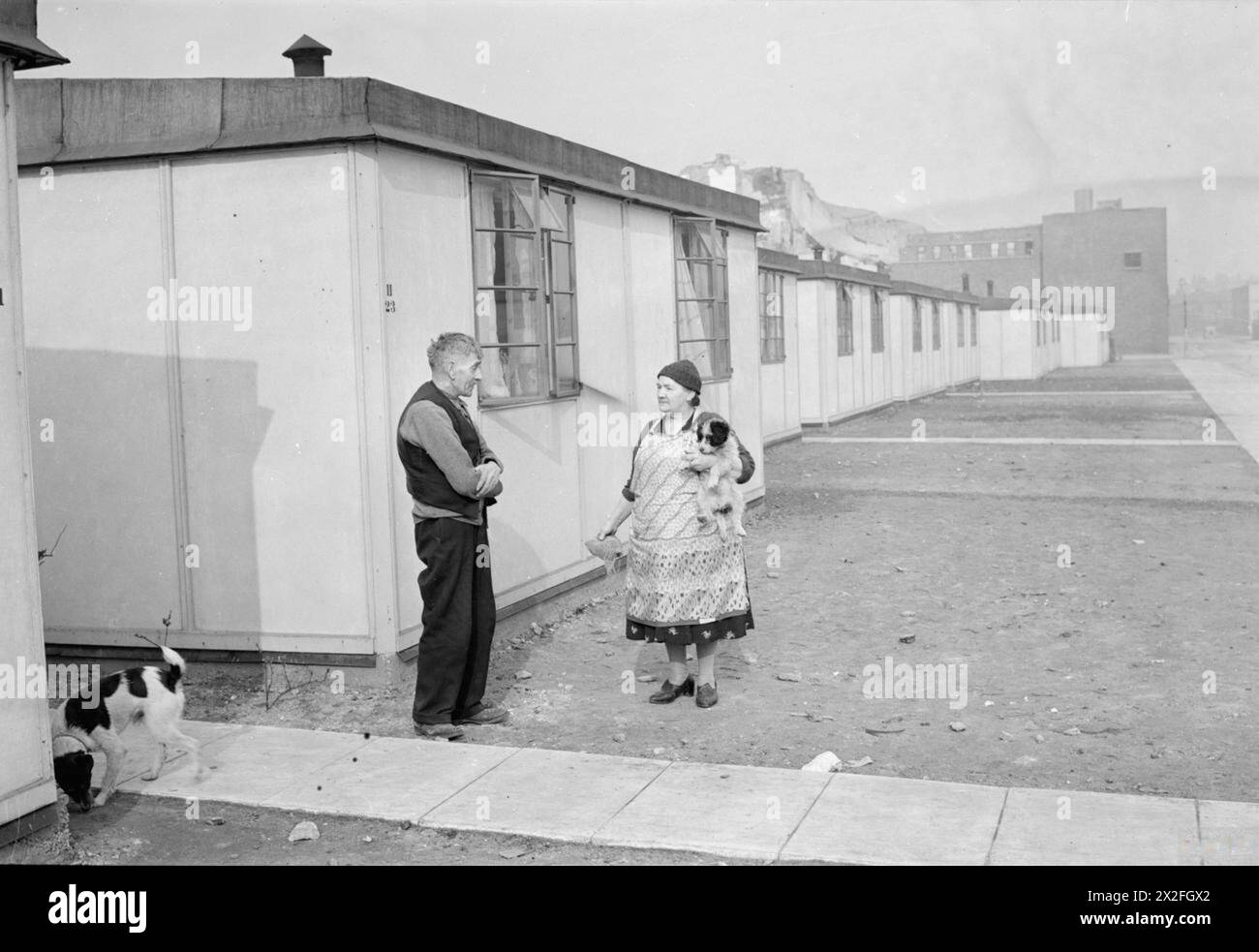 A couple stands outside a newly built Uniseco prefabricated emergency ...