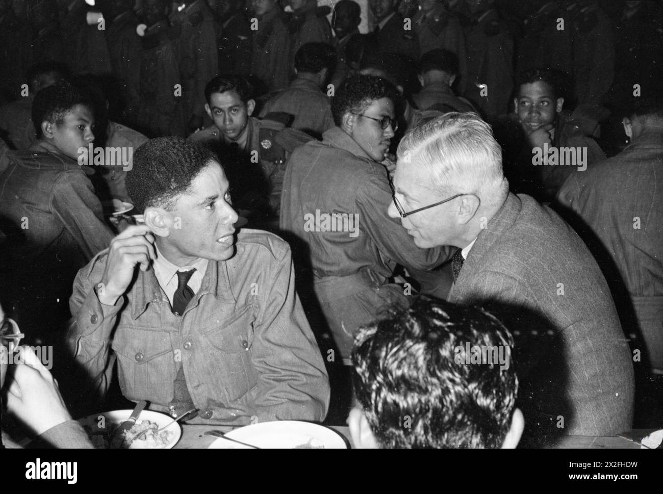 Colonel Oliver Stanley, Secretary of State for the Colonies, talks with ...