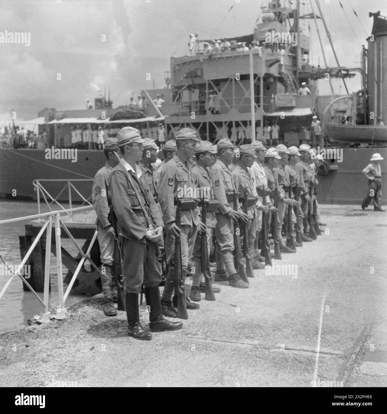 Japanese soldiers form a guard of honour at the quayside in Saigon as ...