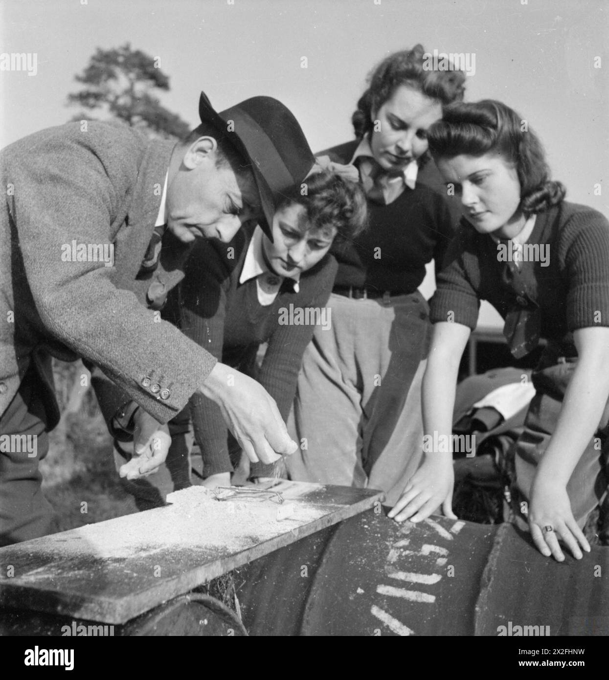 Land Girls Eileen Barry, Audrey Prickett, and Betty Long observe Major ...