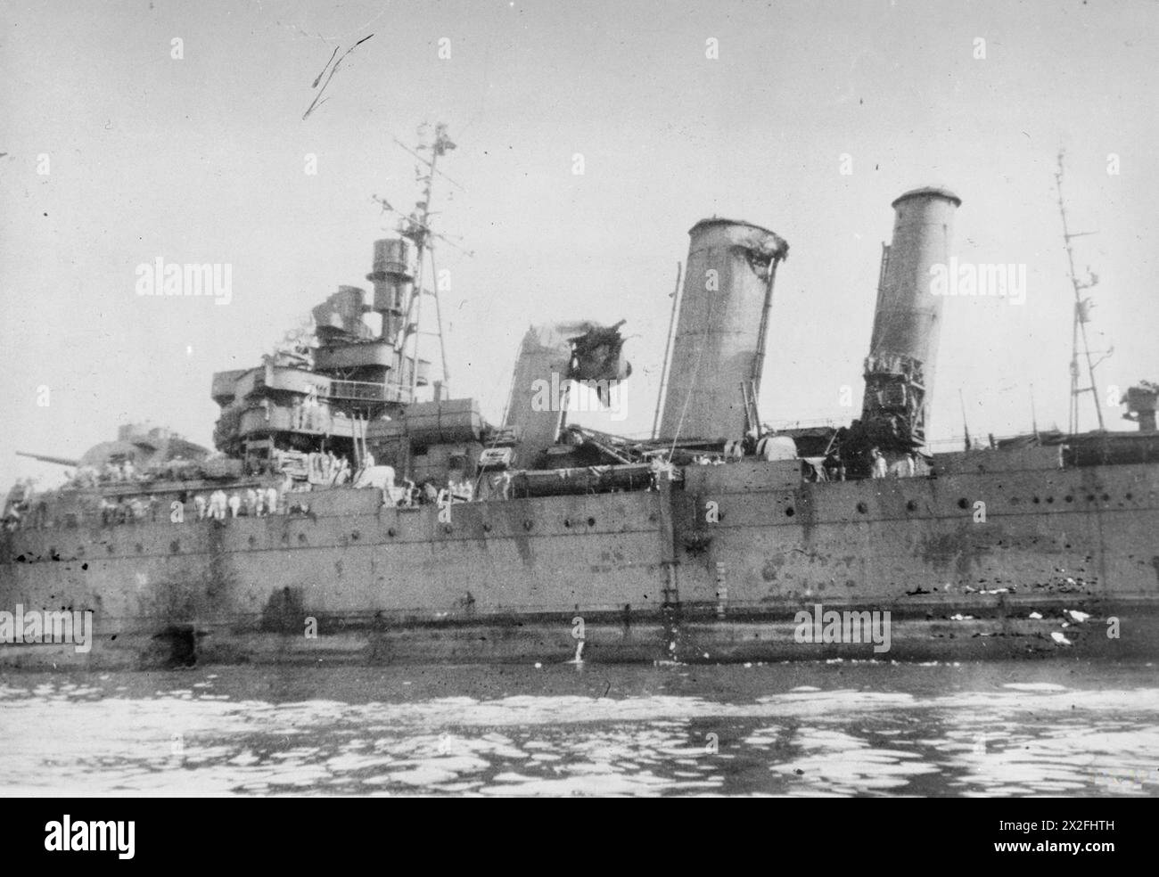The port side of HMAS Australia shows damage caused by a Japanese ...