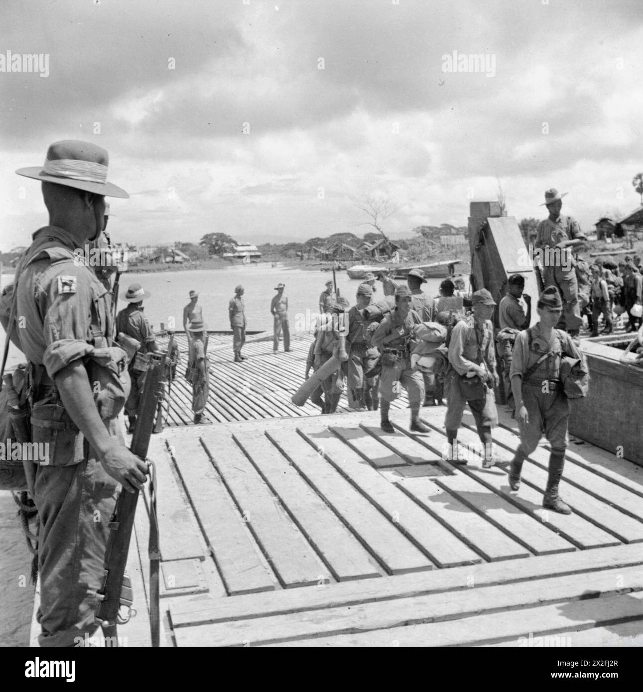 Japanese 52nd Division troops arrive at a bridge on the Sittang River ...