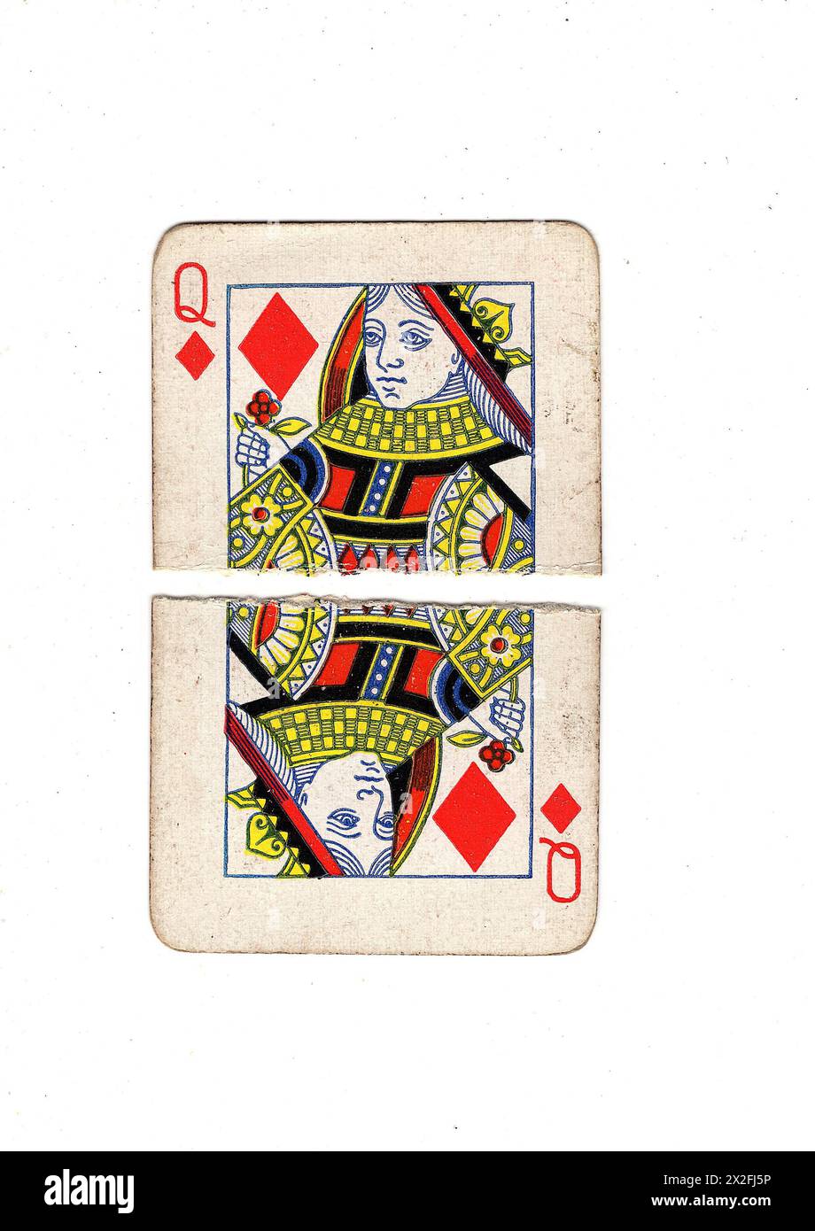 A vintage, well used queen of diamonds playing card torn in half on a ...