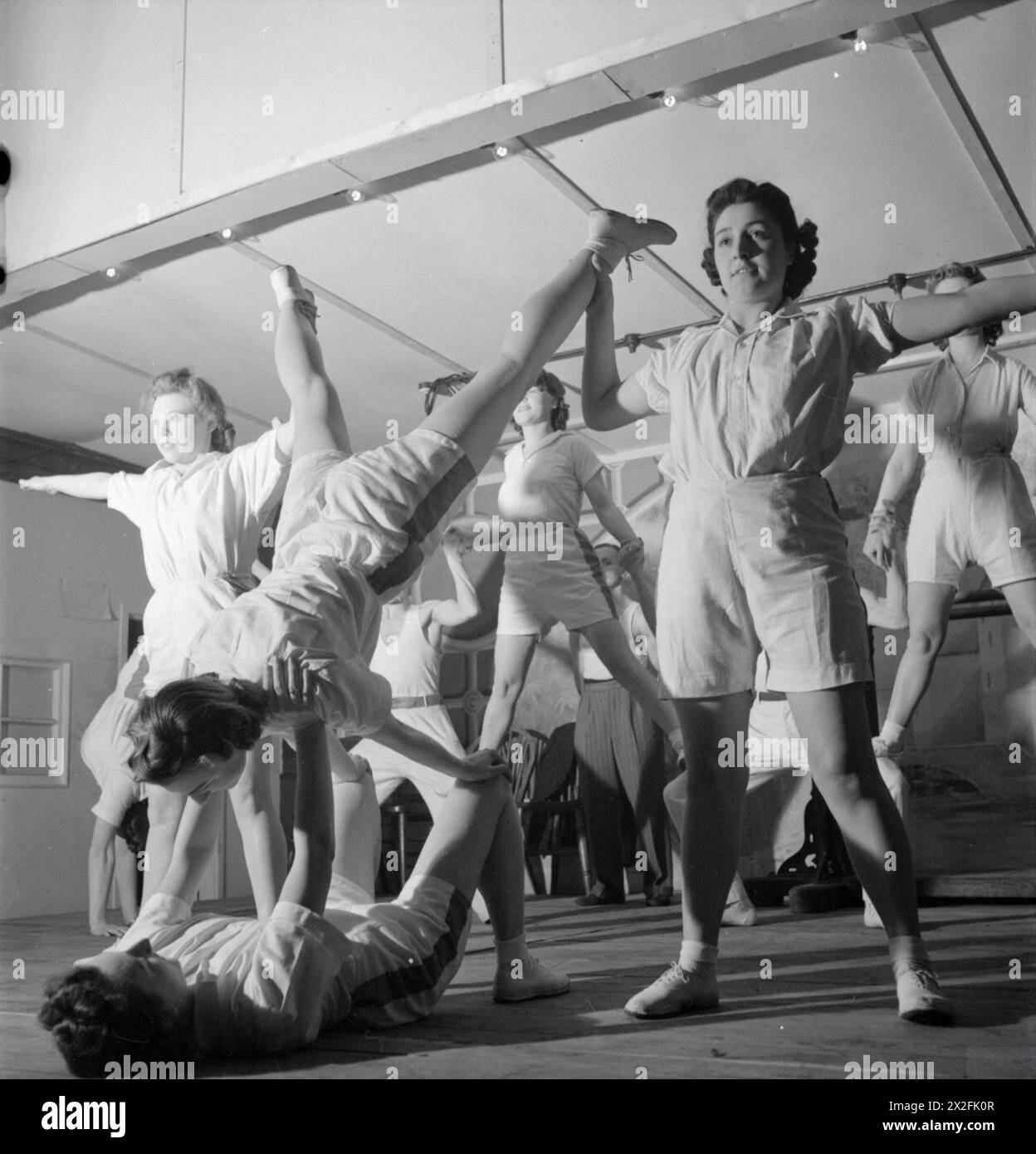 Factory workers perform physical training exercises in a Southern Small ...