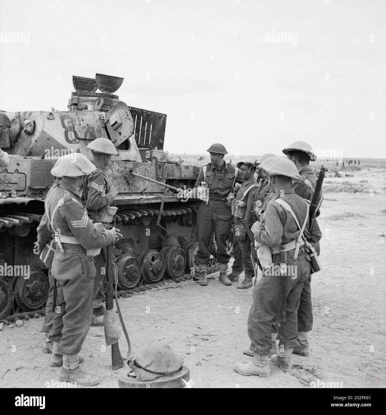 British Army troops observe the effects of anti-tank rounds on a ...