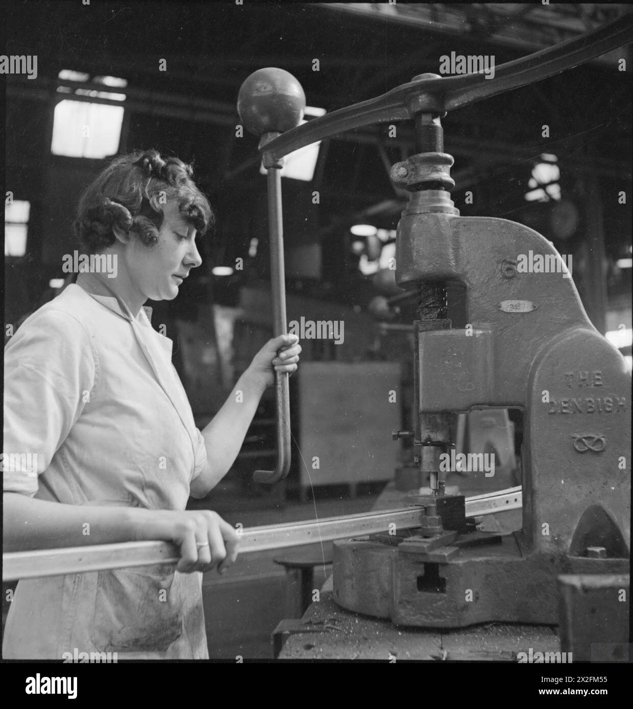 Worker punching holes in metal hi-res stock photography and images - Alamy