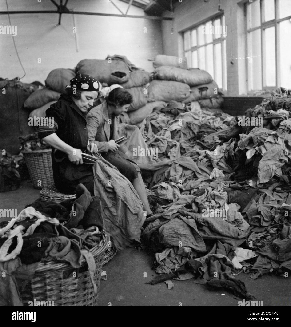 OLD RAGS INTO NEW CLOTH: SALVAGE IN BRITAIN, APRIL 1942 - Women sit on ...