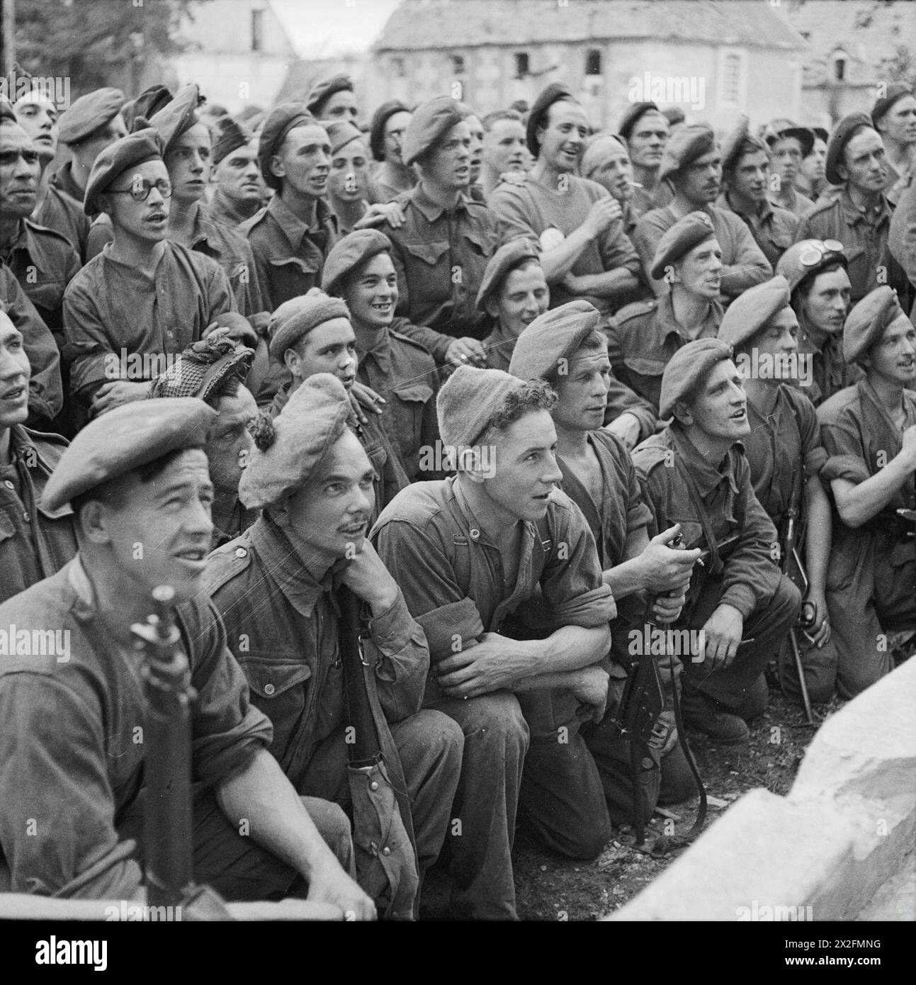 A photograph shows troops in Normandy watching an ENSA performance ...