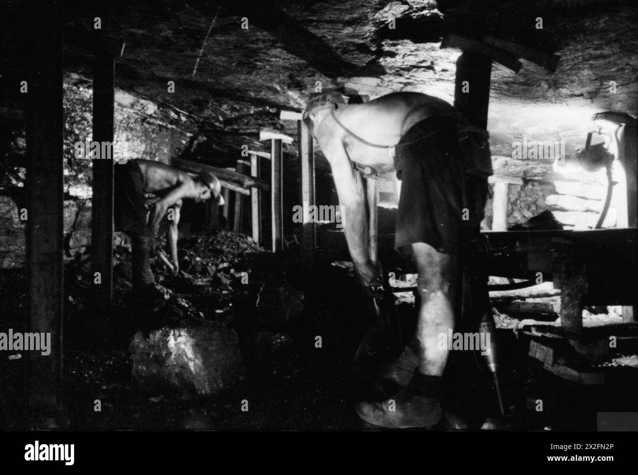 Miners in Britain in 1942 load coal from the coal face onto a conveyor ...