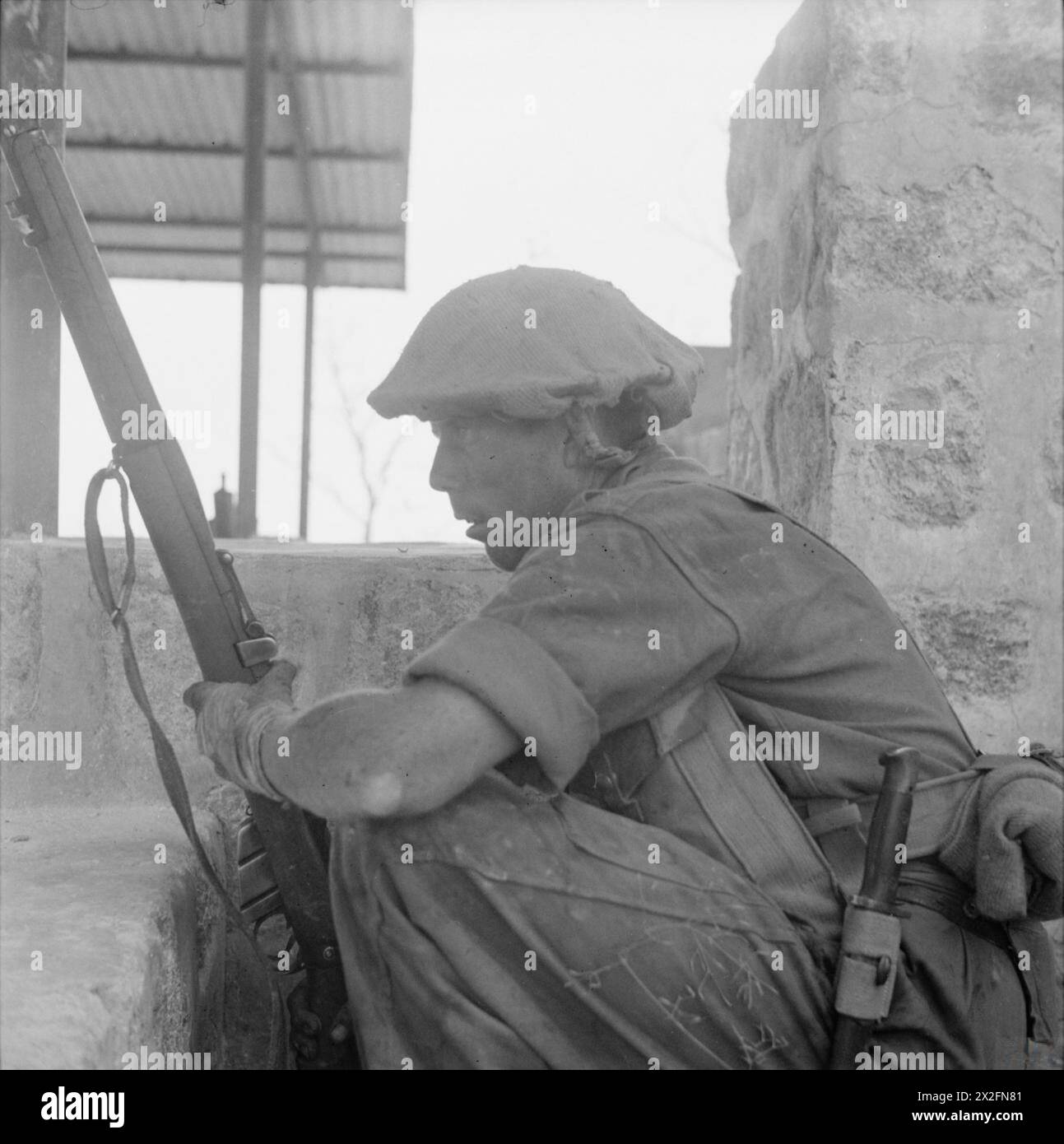 THE BRITISH ARMY IN BURMA 1945 - A soldier of 19th Division holds at ...