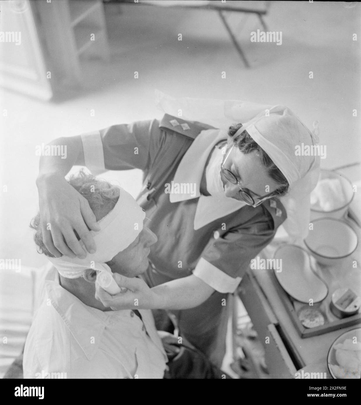 CECIL BEATON IN THE MIDDLE EAST FEBRUARY-JULY 1942 - A nurse bandages ...