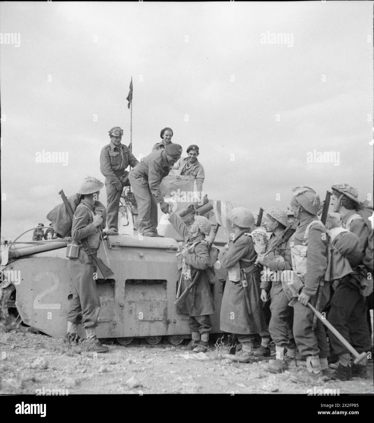 New Zealand infantry greet a Matilda tank crew after the meeting of the ...