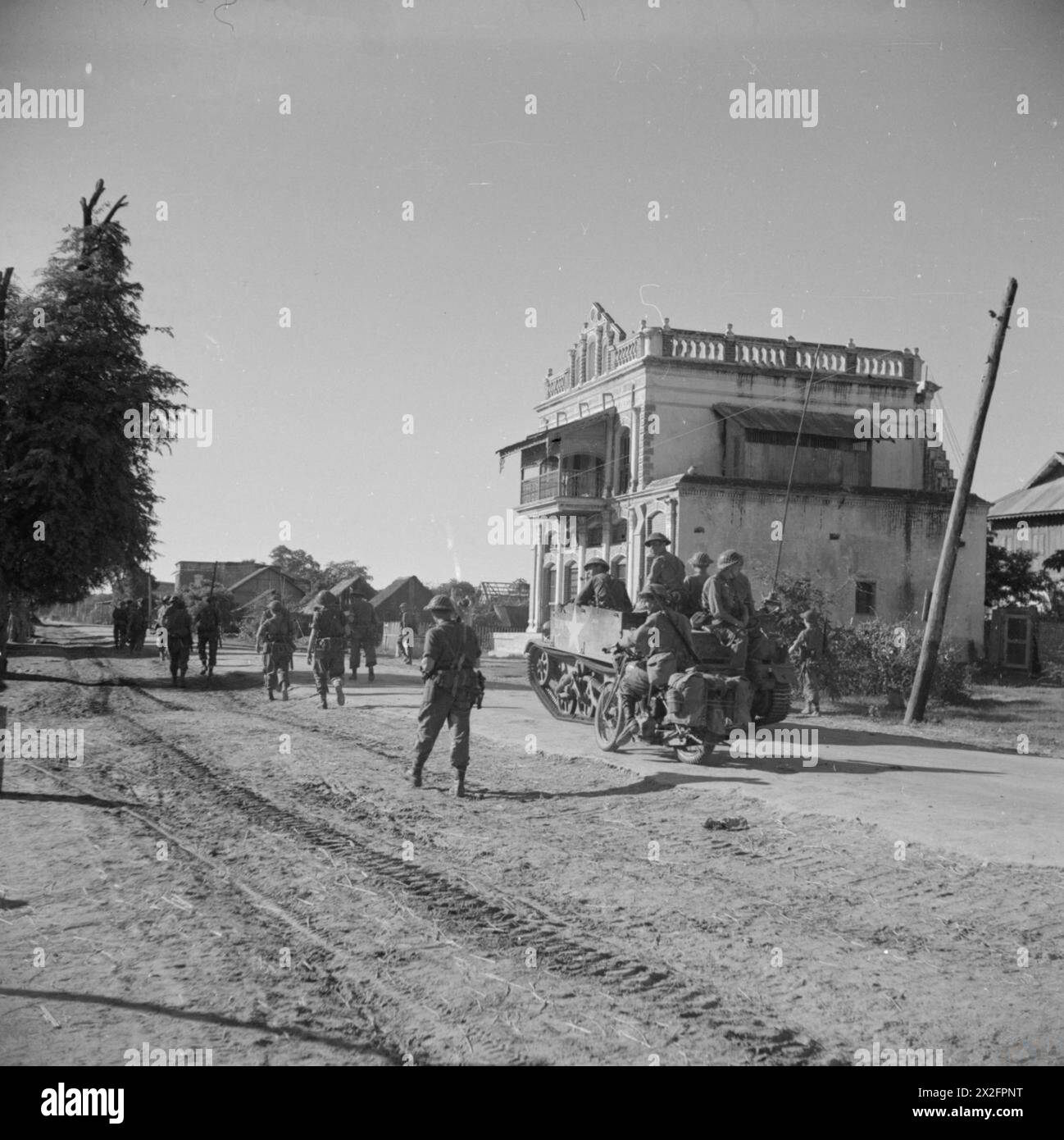 THE BRITISH ARMY IN BURMA 1945 - A Bren gun carrier and infantry enter ...
