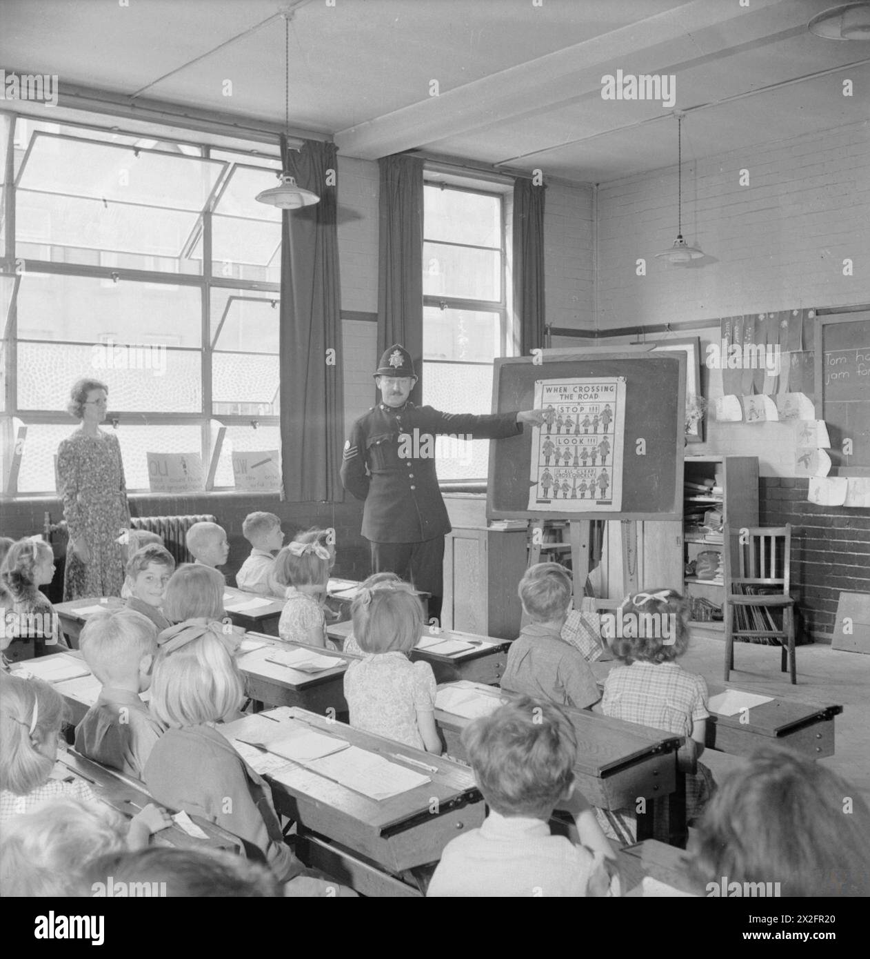 Photograph showing a police sergeant teaching road safety to children ...