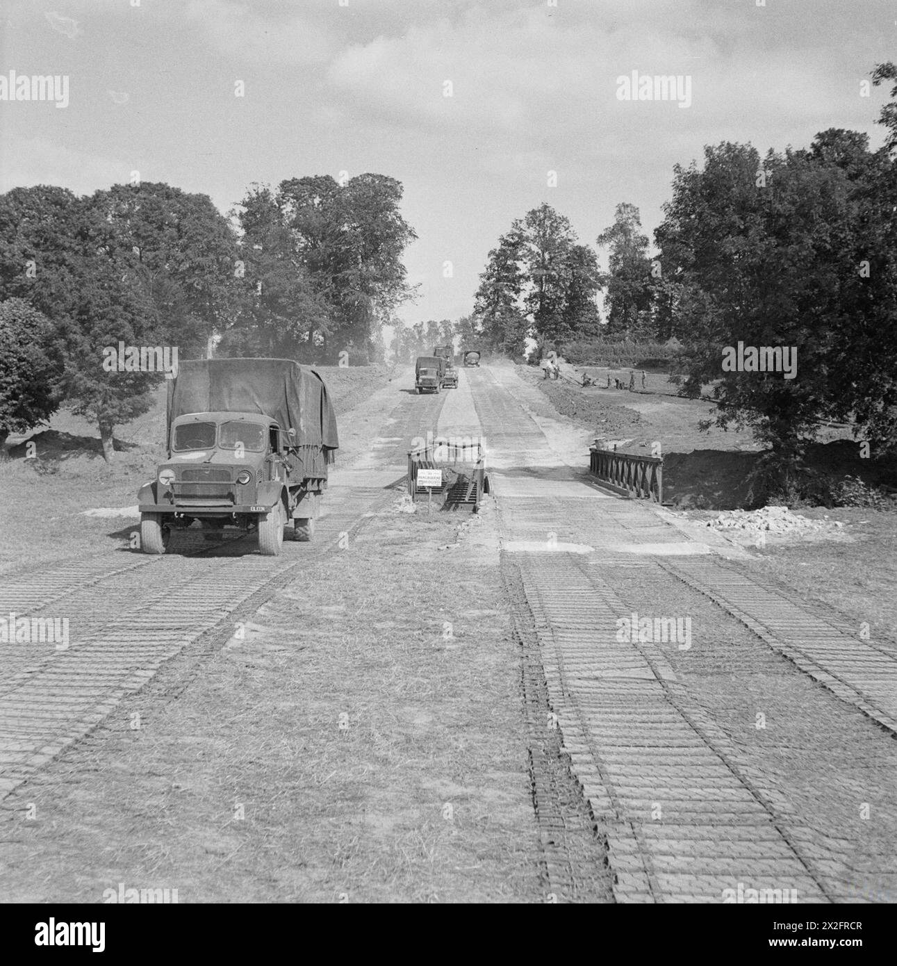 British Army troops advance along the Bayeux by-pass in North-West ...
