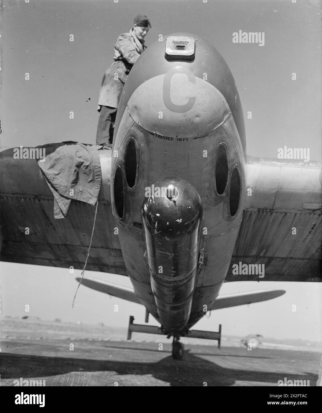 A member of the Royal Air Force Coastal Command ground crew prepares a ...
