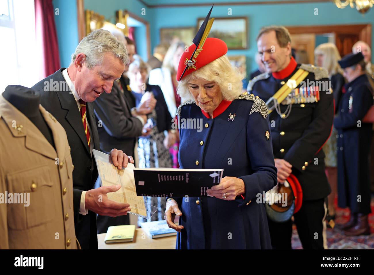 Queen Camilla views a photograph of Veteran Royal Lancers including ...