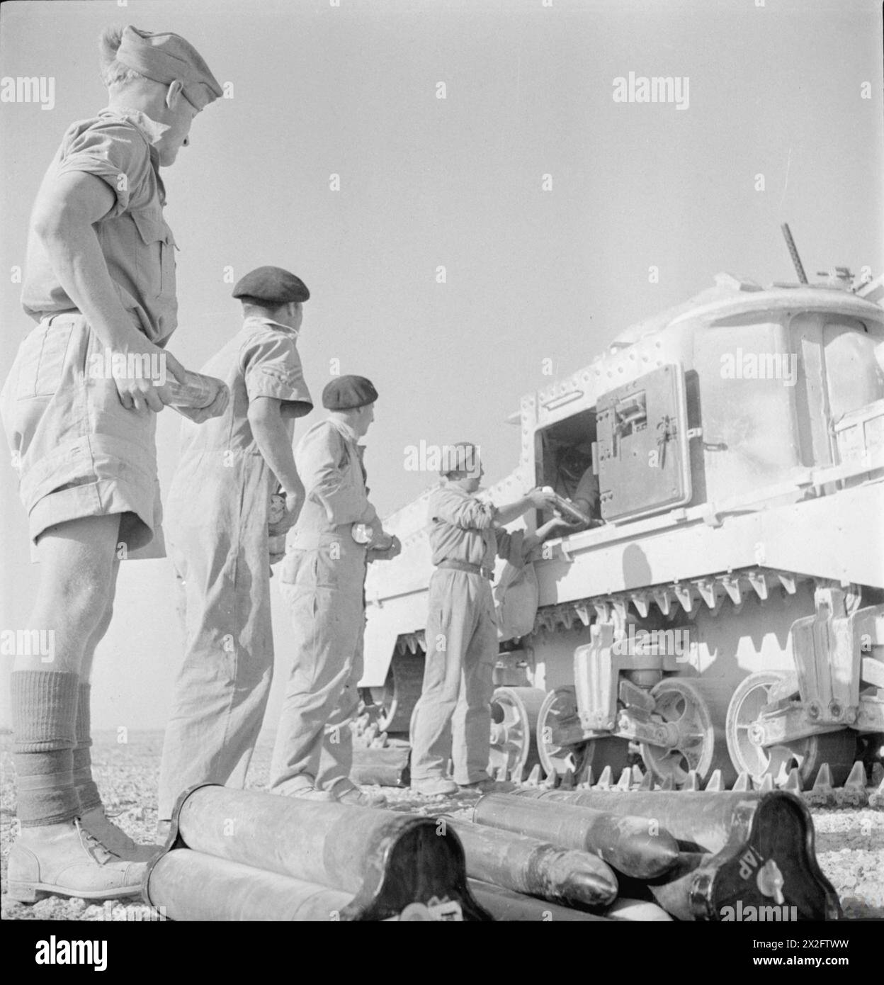 In the Western Desert, Cecil Beaton photographed soldiers loading shells into a Grant tank ...