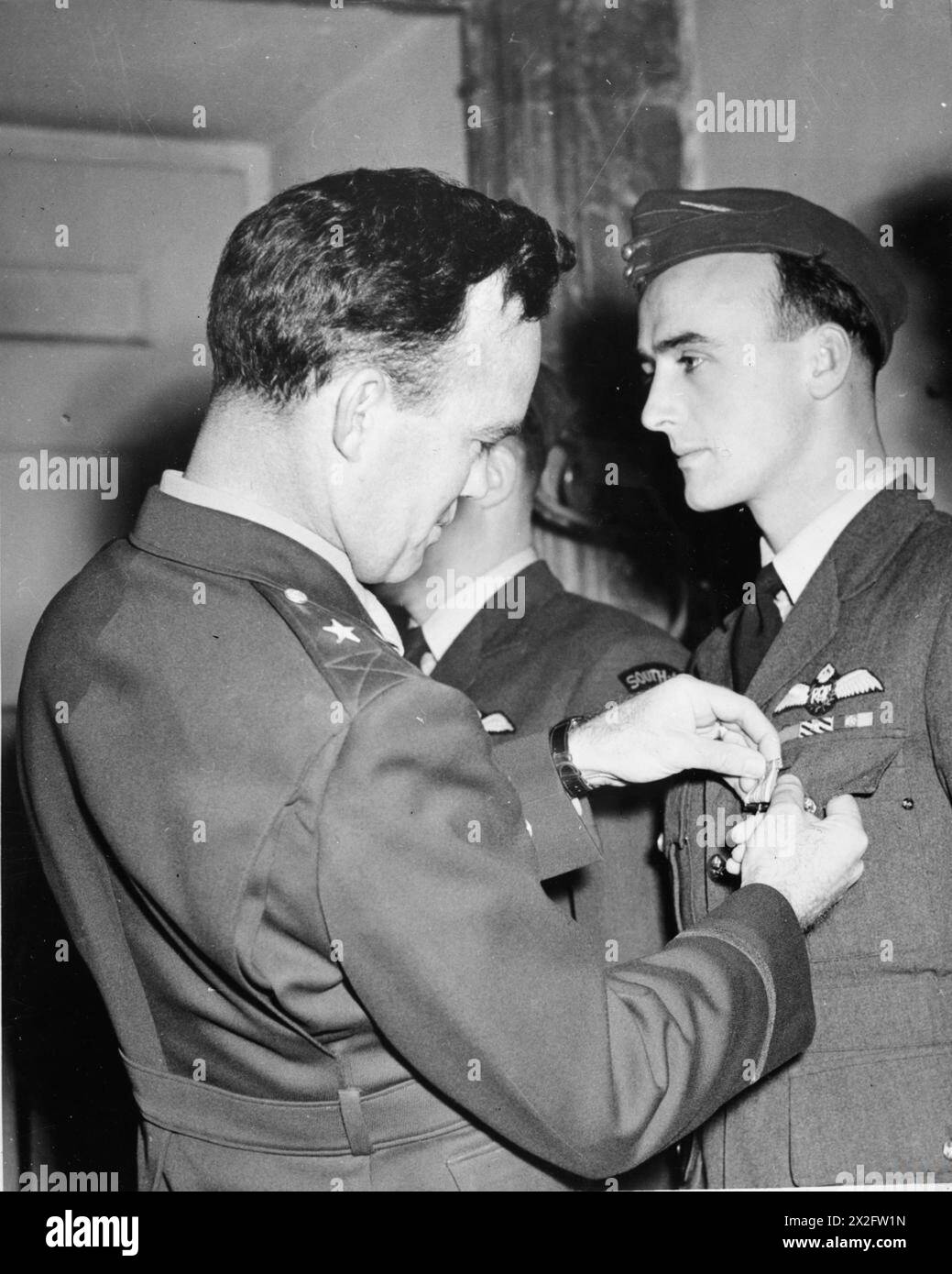 Wing Commander A D J Lovell of the RAF receives the American ...