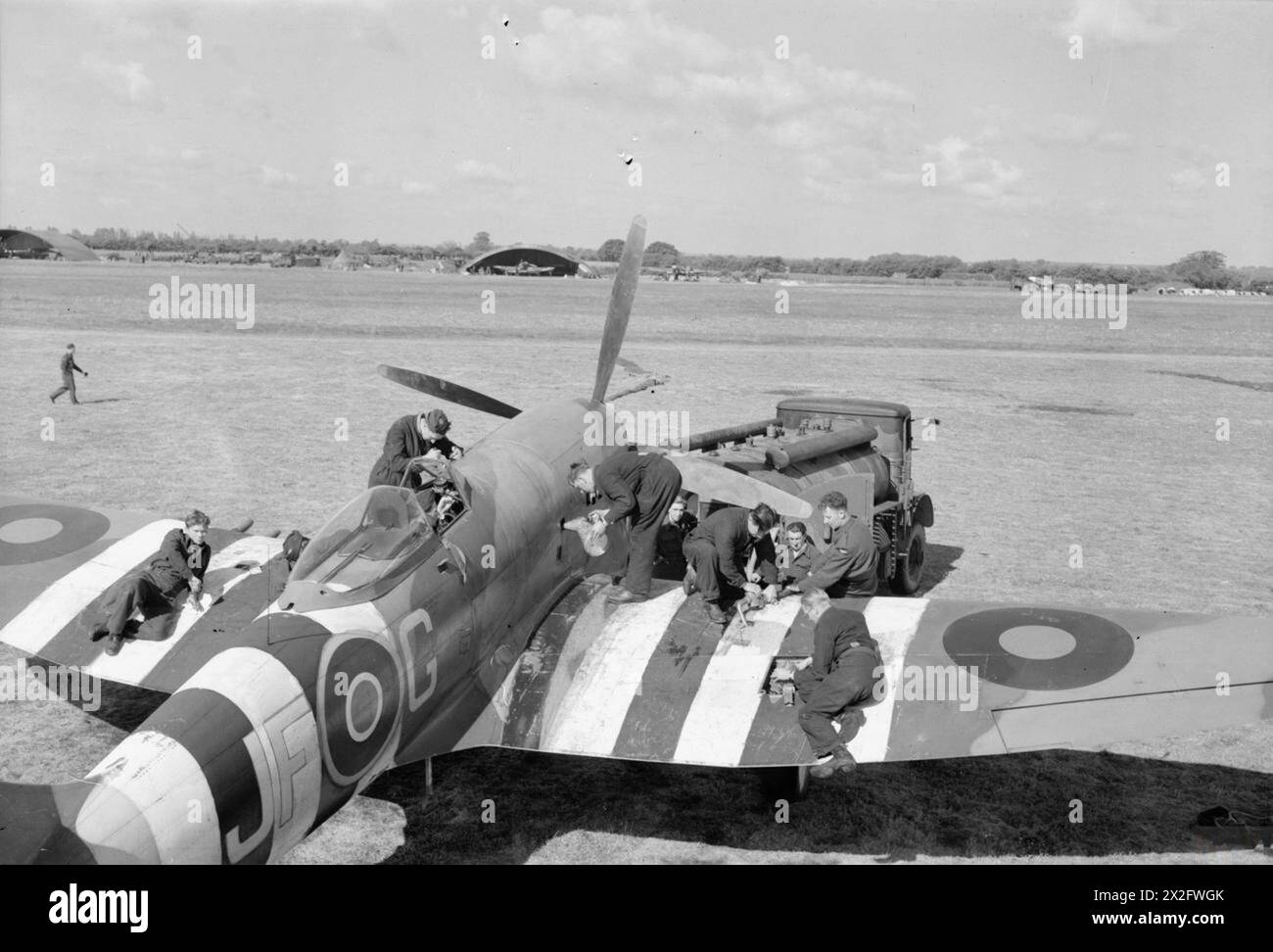 Ground crew refuel and re-arm Hawker Tempest Mark V 'JF-G' of No. 3 ...