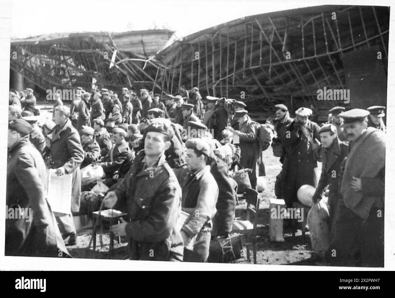 British P.O.Ws from Oflag 12B await air transport at Geiseen airfield ...