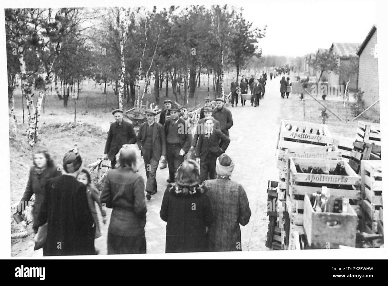 Photograph showing German civilians walking within a camp during ...