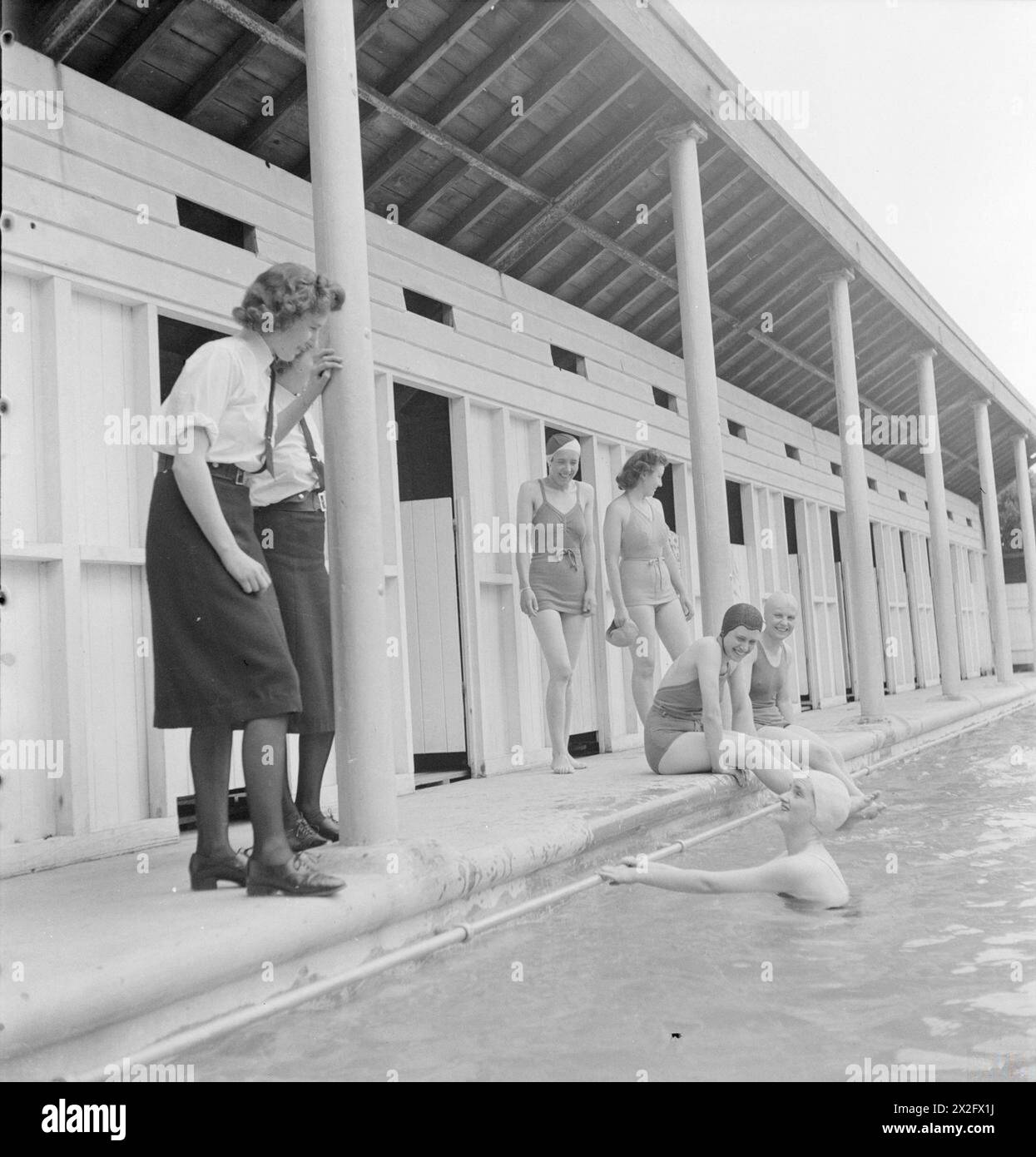 WOMEN'S ROYAL NAVAL SERVICE. - Wren stewards having a swim in the pool ...