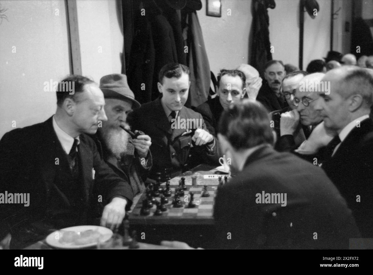 A Royal Air Force pilot observes a chess game at the Gambit Chess Rooms ...