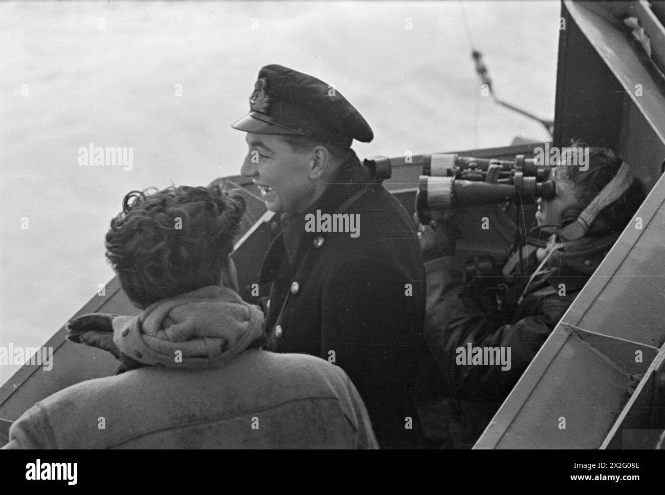 Look-outs stand on the compass platform aboard HMS King George V en ...