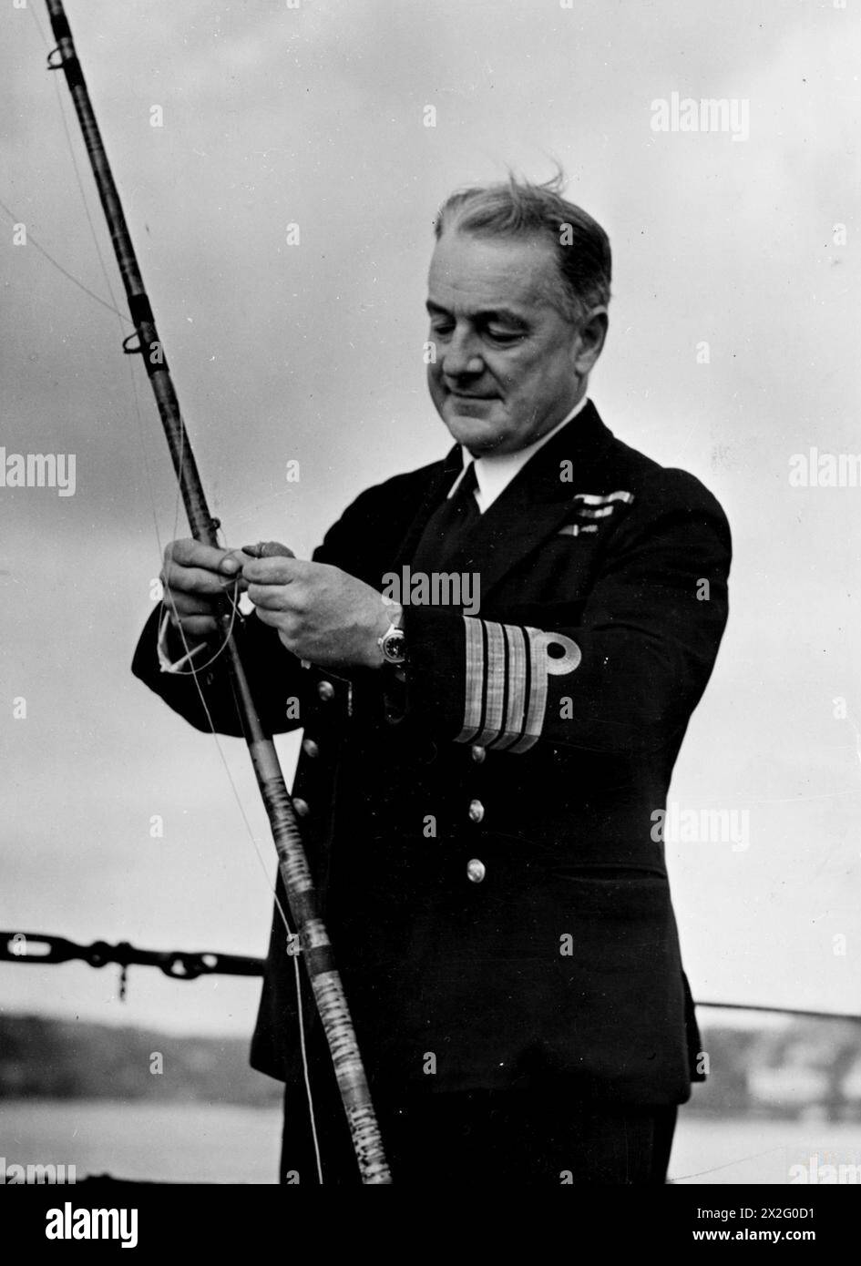 In August 1945, Captain J.S. Bethell, CBE, RN, of HMS Bermuda fishes ...
