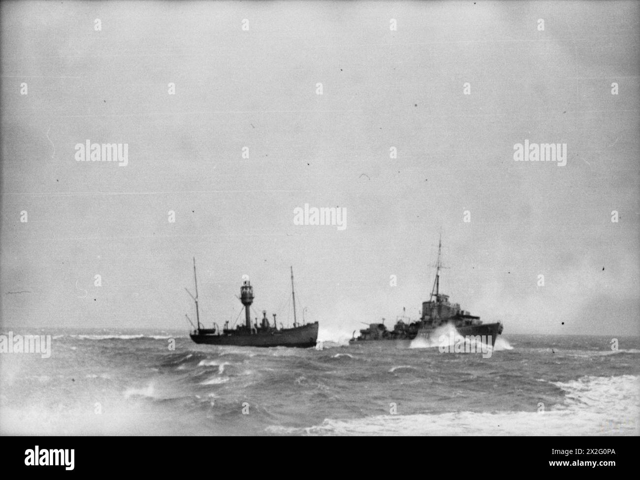 HMS Jersey, a destroyer, rounds the Humber Lightship off Grimsby while ...