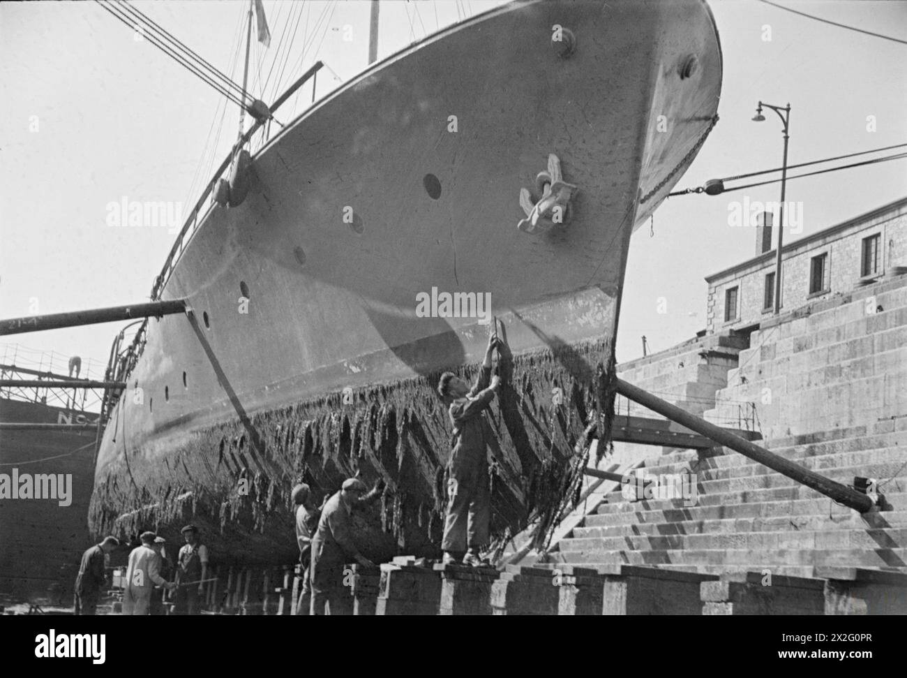 In 1940 at Plymouth, a private yacht requisitioned for naval service is ...